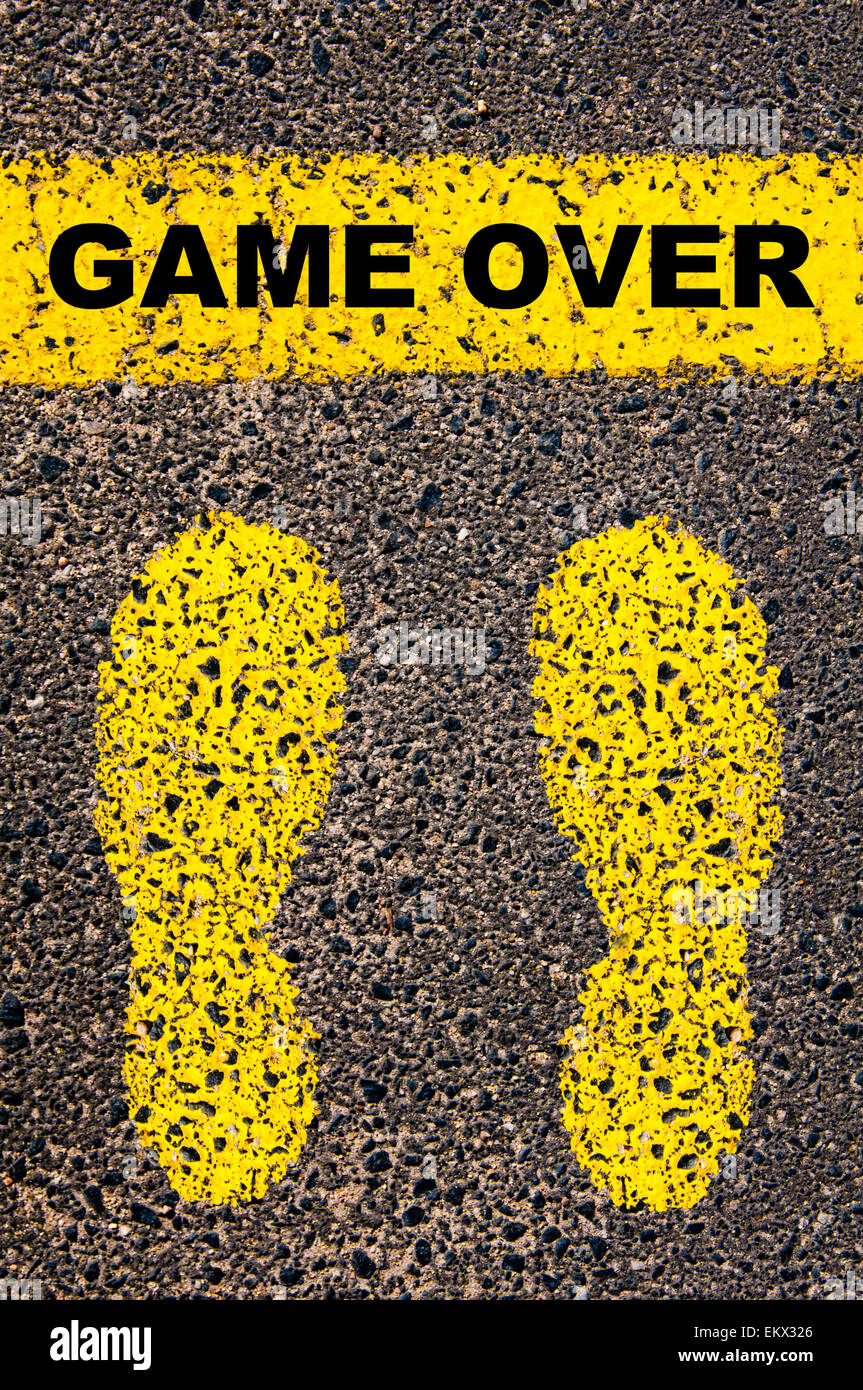 Game Over message. Conceptual image with yellow paint footsteps on the ...
