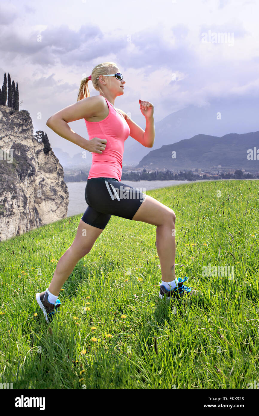 a young woman jogging through rural landscape Stock Photo - Alamy