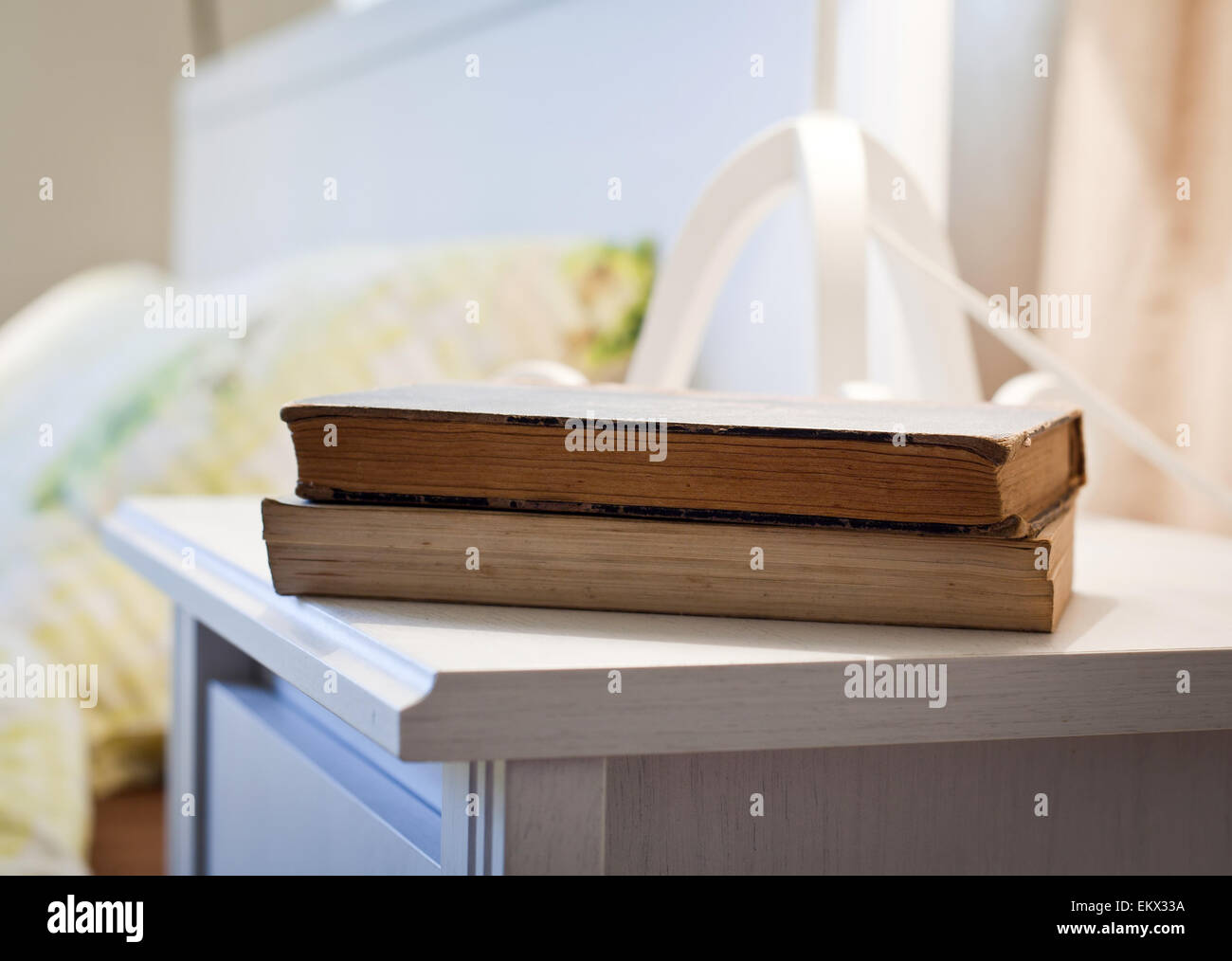 bedroom with books on nightstand Stock Photo - Alamy