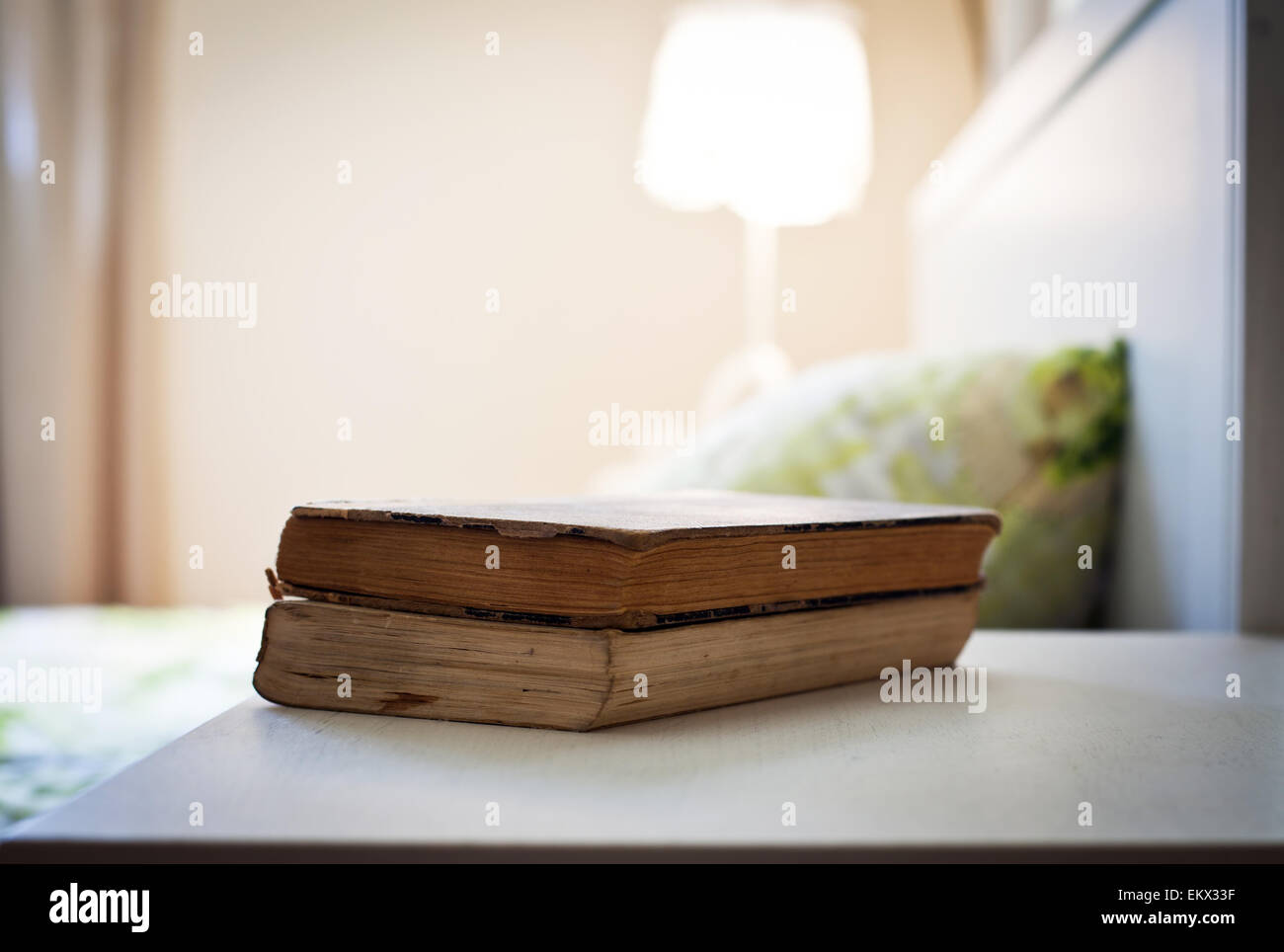 bedroom with books on nightstand Stock Photo - Alamy