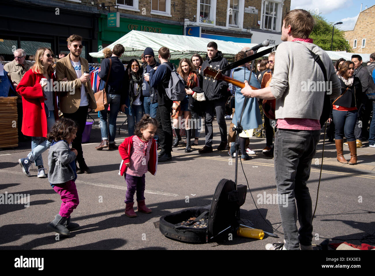 Hackney Spring 2015. Broadway market. Busker and little girls Stock ...