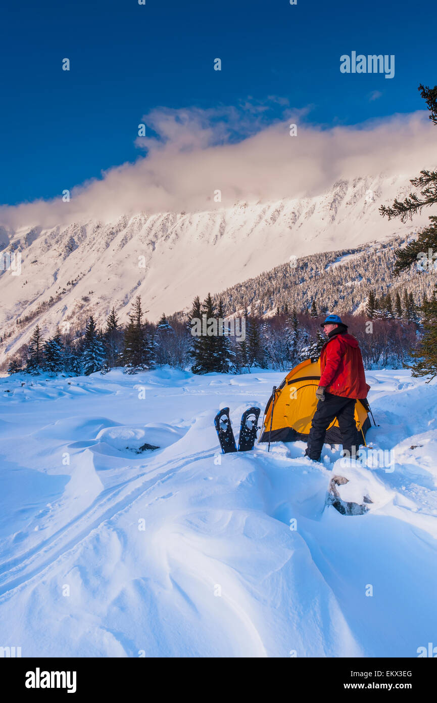 A man at his winter campsite on Bird Point with Turnagain Arm in the ...