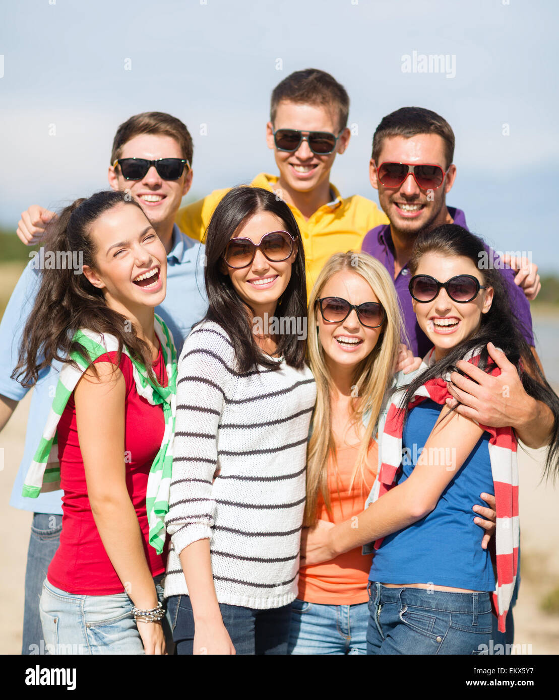 group of happy friends hugging on beach Stock Photo - Alamy