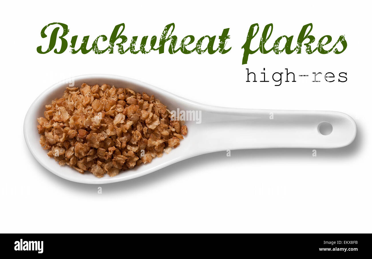Buckwheat flakes in white porcelain spoon / high resolution product photography of seed in white ...