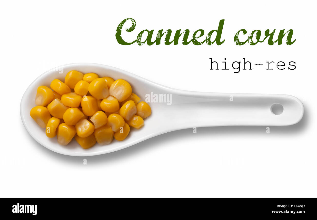 Canned corn in white porcelain spoon / high resolution product photography of seed in white ...