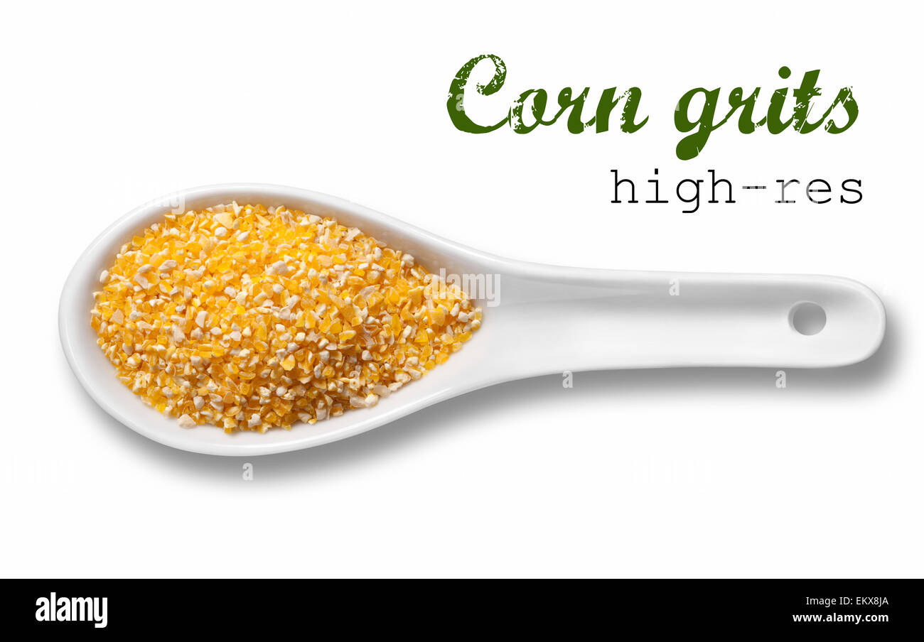 Yellow corn grits in white porcelain spoon / high resolution product photography of seed in ...