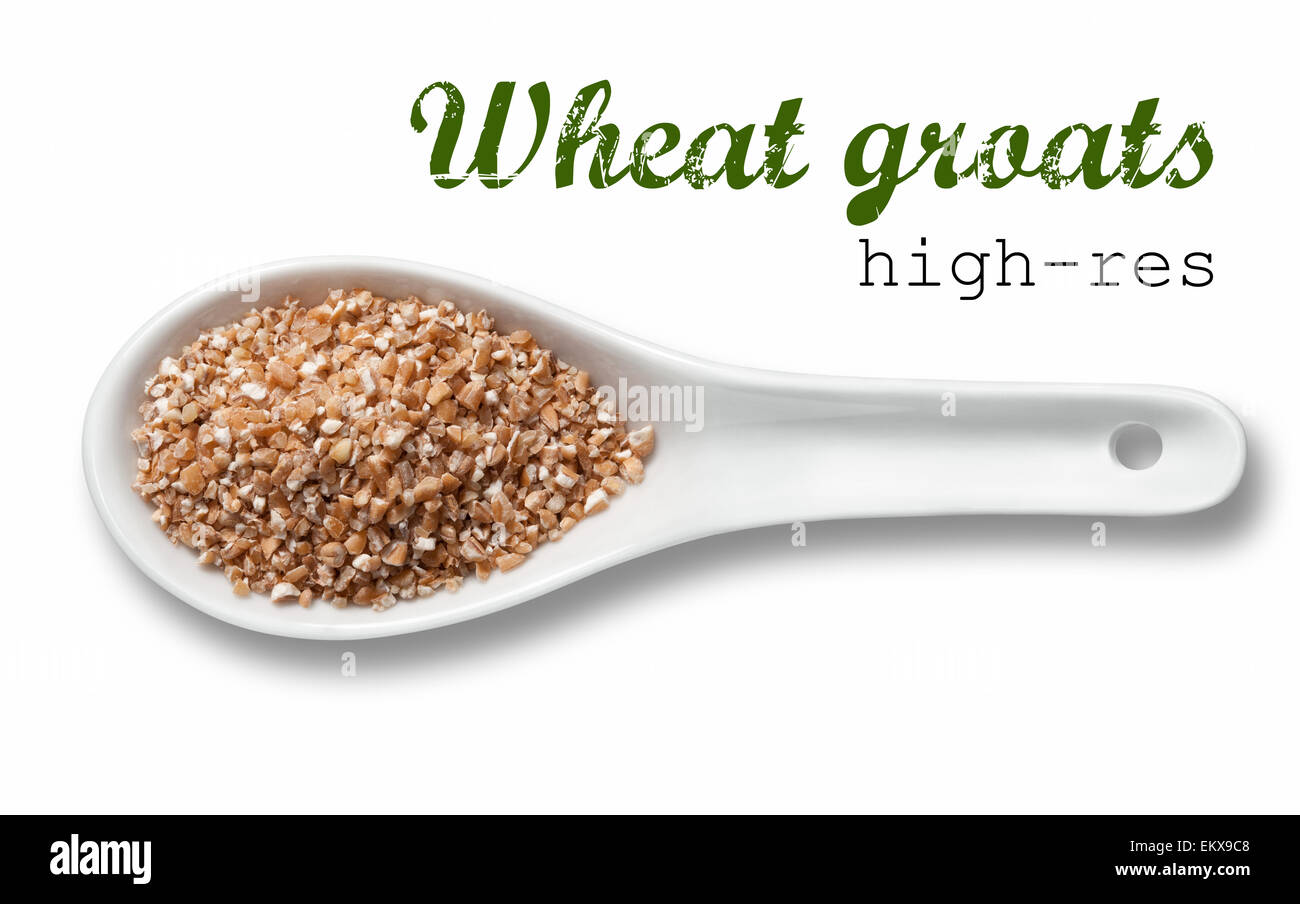 Wheat groats in white porcelain spoon / high resolution product photography of seed in white ...
