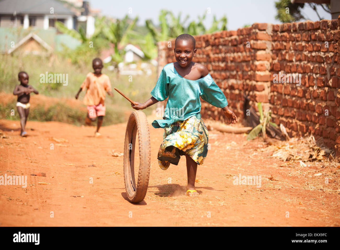 Children Running After A Rolling Tire; Kampala Uganda Africa Stock ...