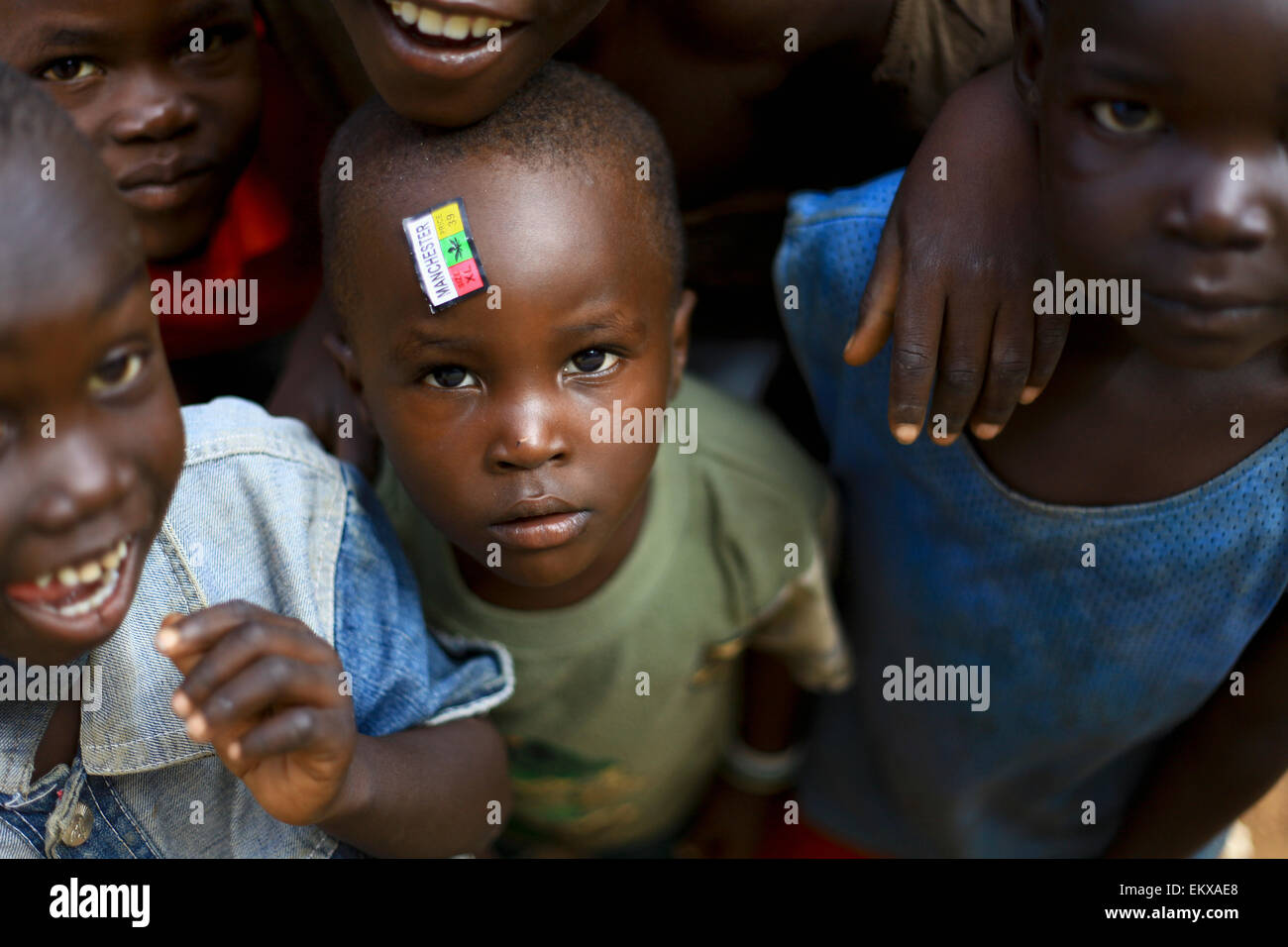 A Child With A Sticker On His Forehead In A Group Of Children; Kampala ...