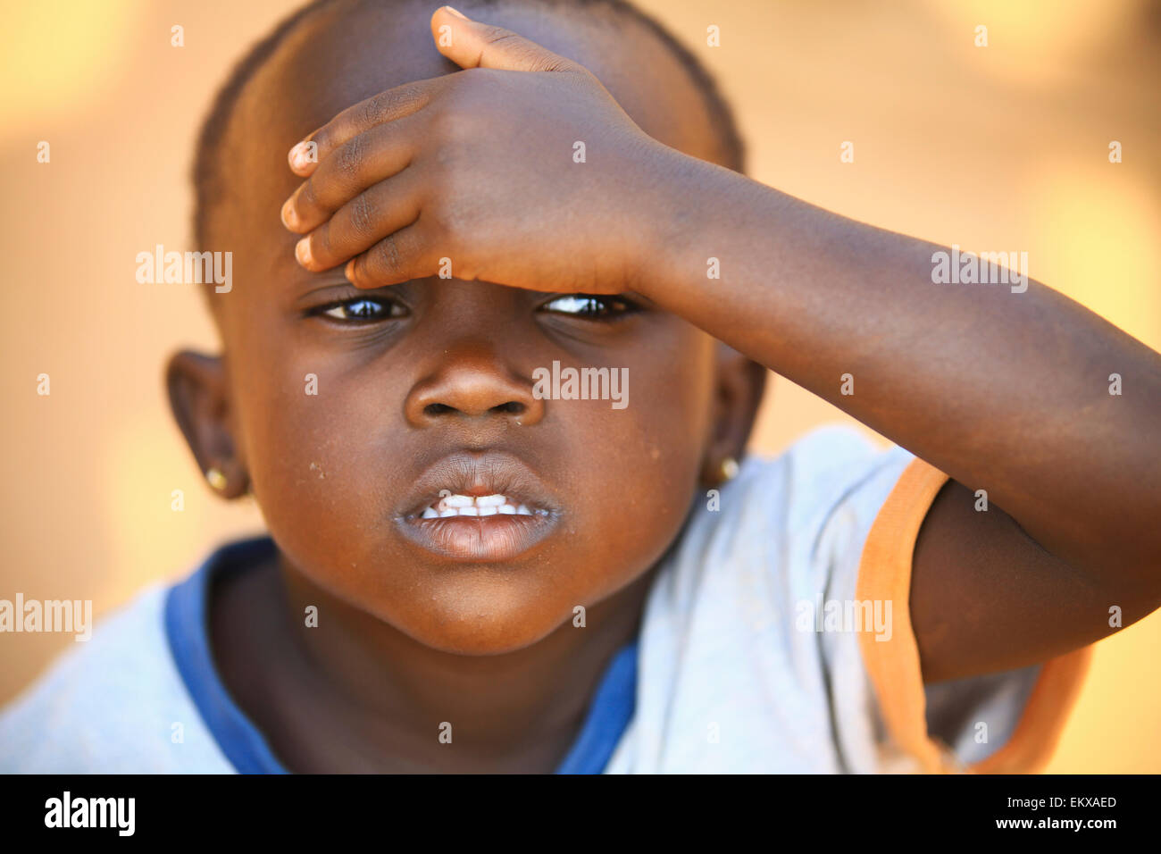 A Young Girl With Her Hand On Her Forehead; Kampala Uganda Africa Stock ...