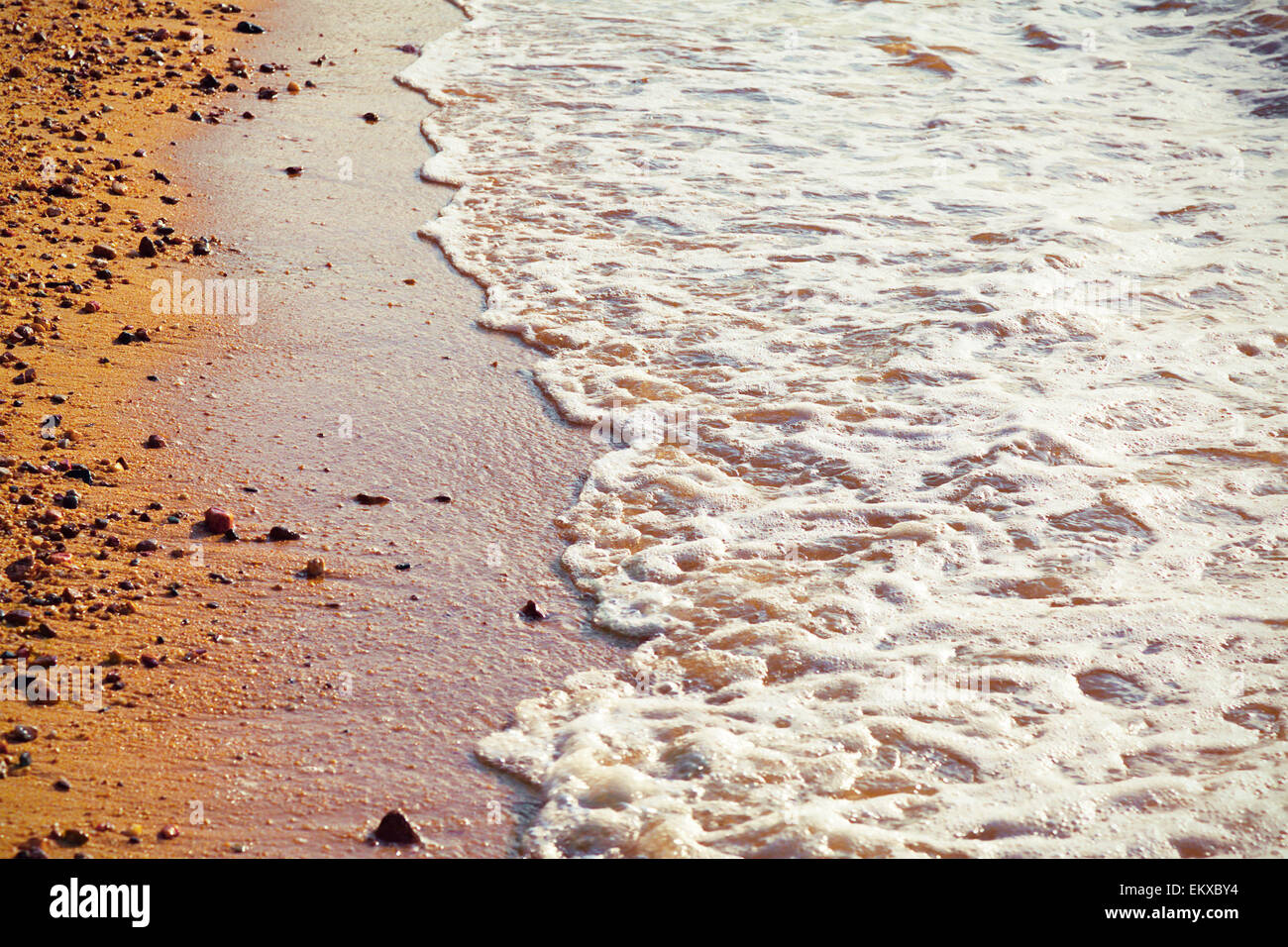 sand and wave background at sunset time Stock Photo - Alamy