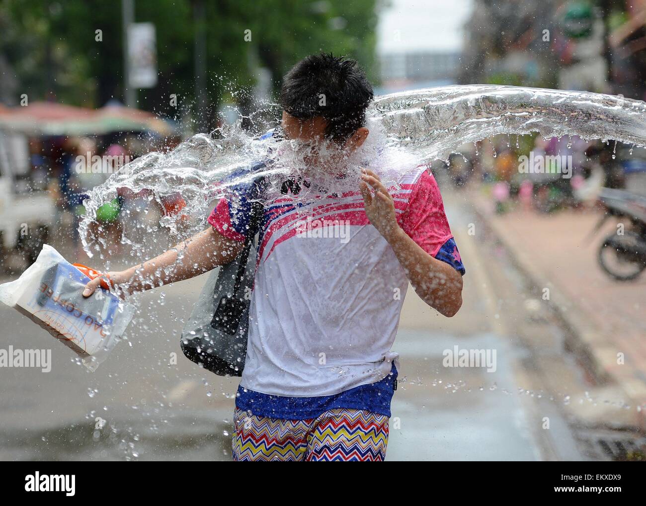 Vientiane, Laos. 14th Apr, 2015. A man is hit by splashing water in ...