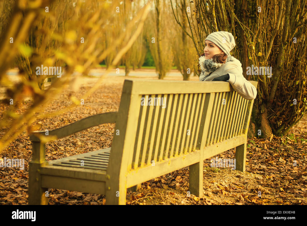Woman sitting on bench Stock Photo - Alamy