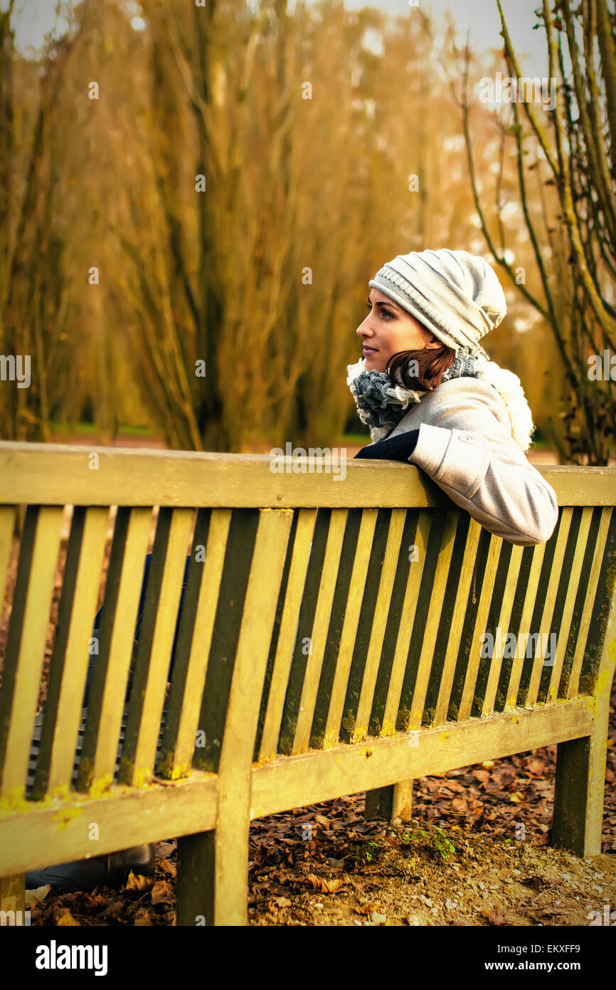 Woman sitting on bench Stock Photo - Alamy