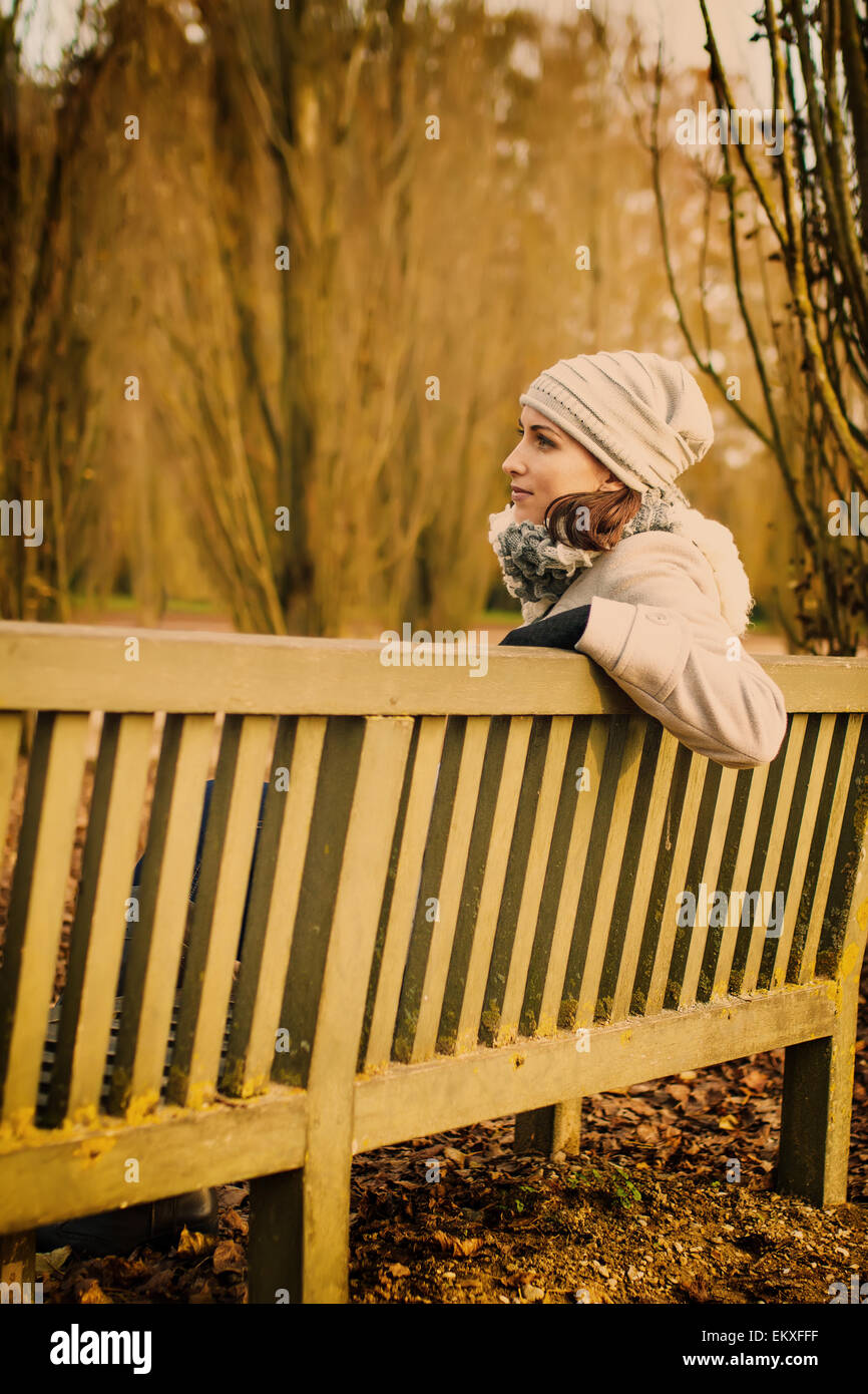Woman sitting on bench Stock Photo - Alamy