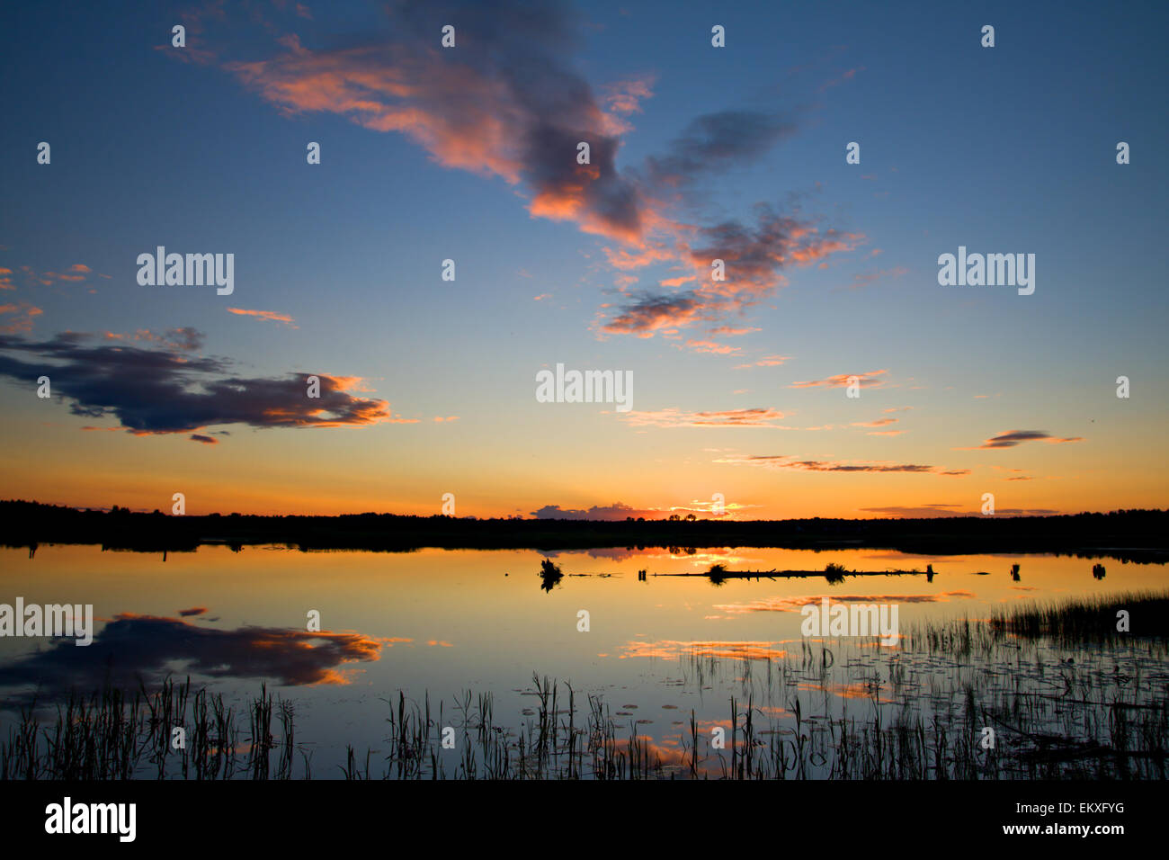 sunset over water Stock Photo - Alamy