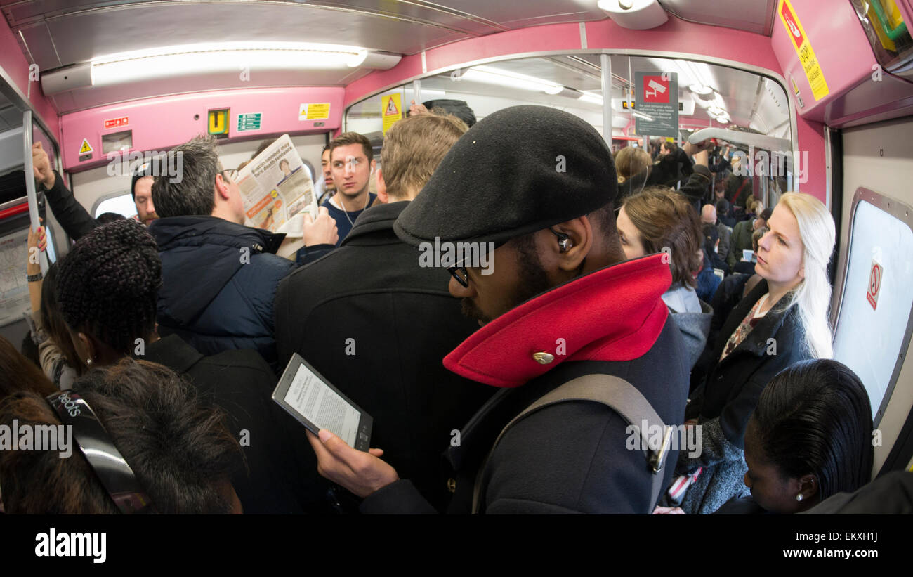 Packed overcrowded London commuters in overground train squeezed in ...