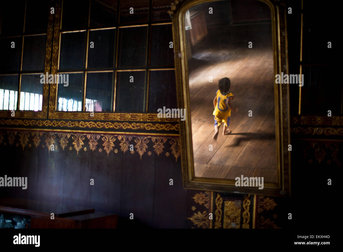 Reflection In A Mirror Of A Young Girl Running Through The House ...
