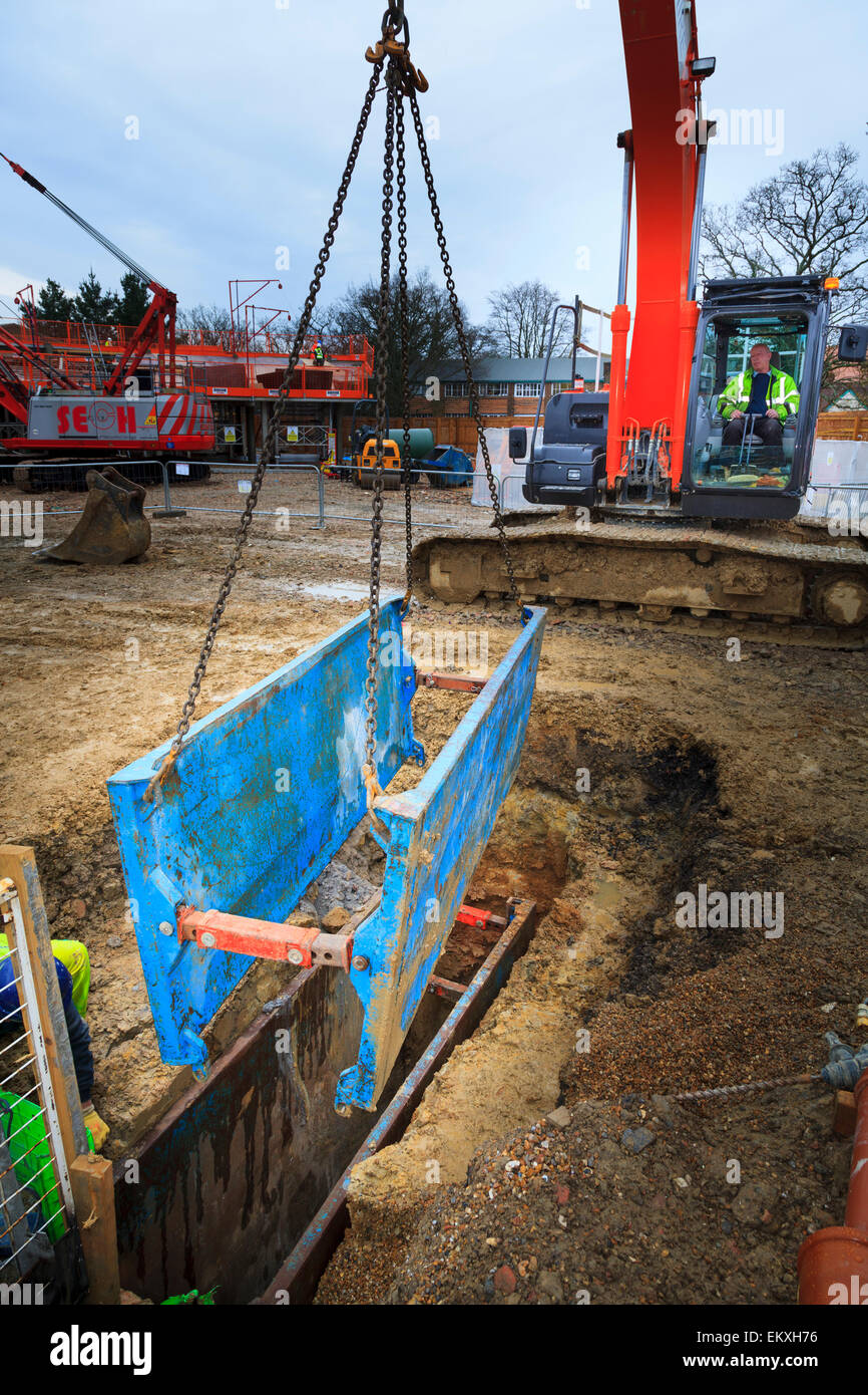 Mobile crane placing metal shoring to trench Stock Photo - Alamy