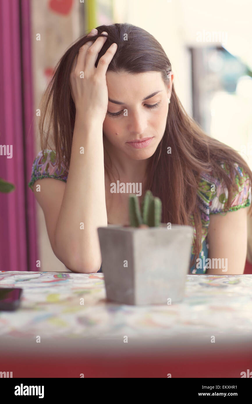 Young latin woman at street bar worried Stock Photo - Alamy