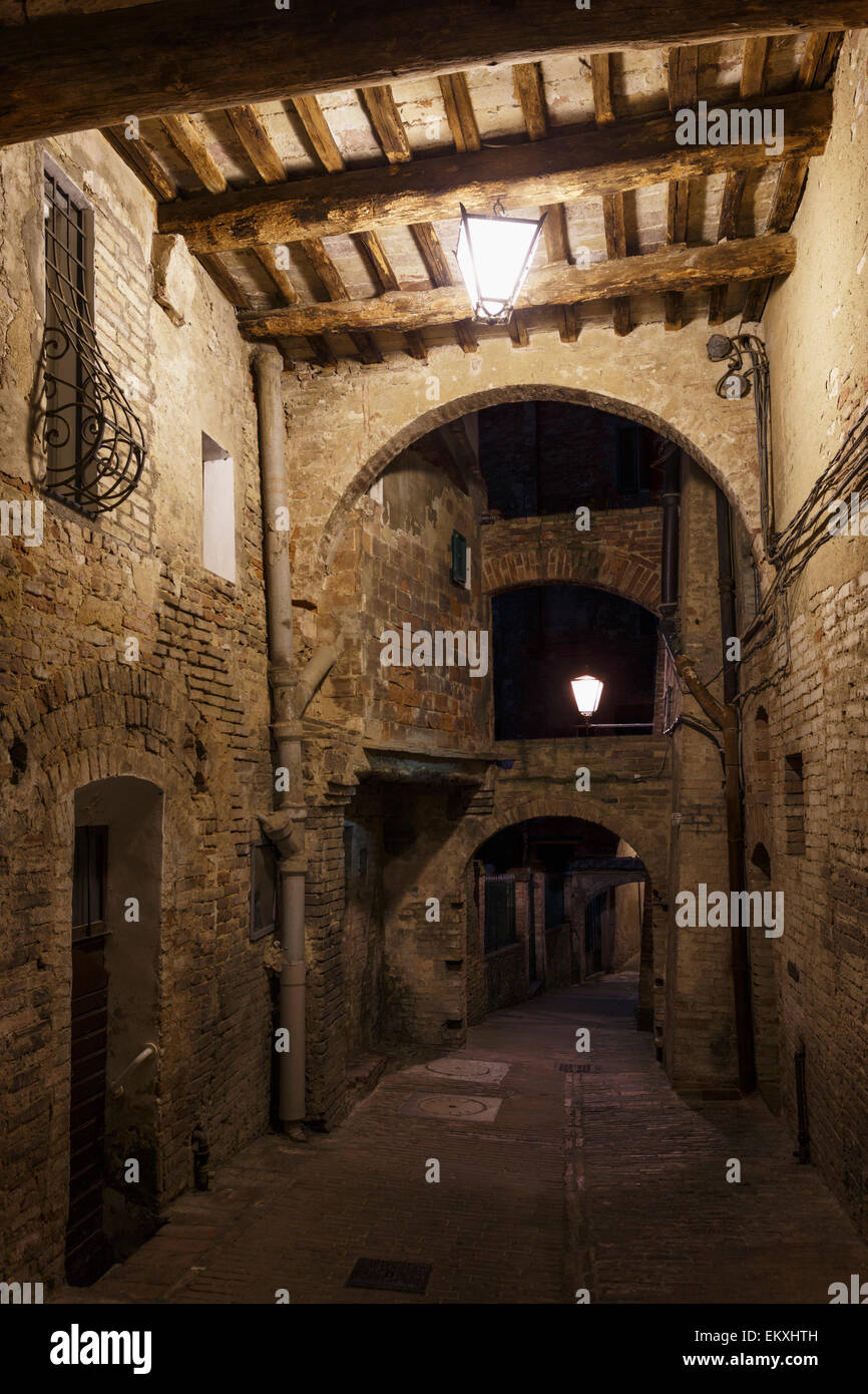 A medieval alley of the historic center of Siena, Tuscany, Italy Stock ...