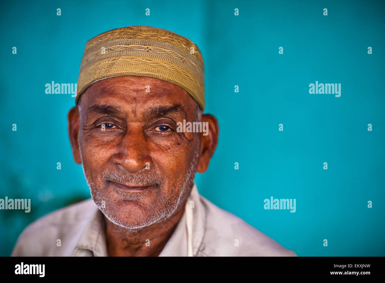 A Tamil Muslim Man Against A Blue Wall; George Town Penang Malaysia ...