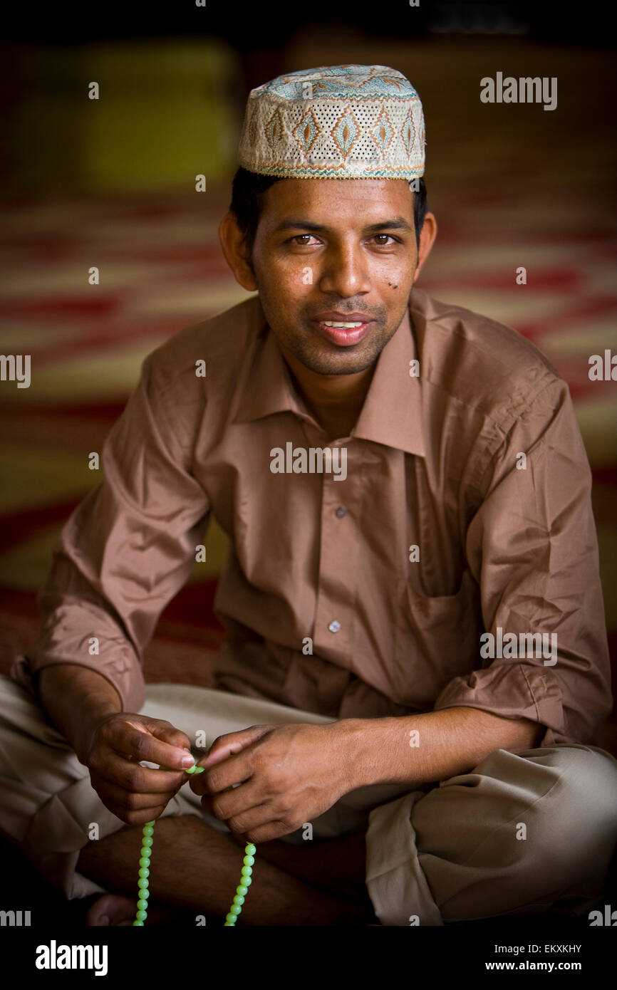 Portrait Of A Young Man Wearing A Prayer Cap With His Prayer Beads ...