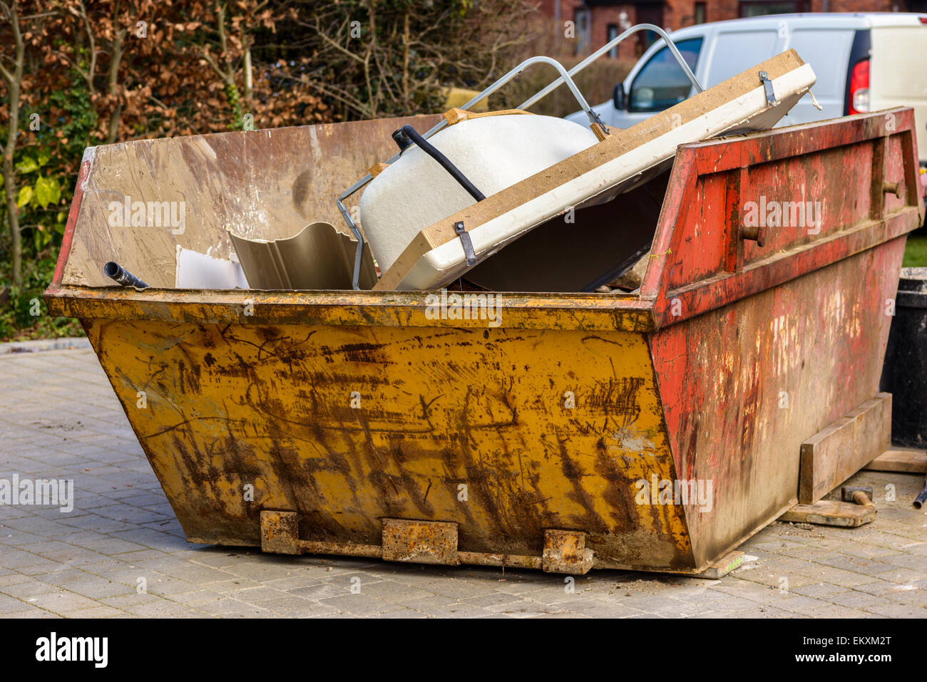 Household waste in a skip dumpster on a residential driveway during a ...