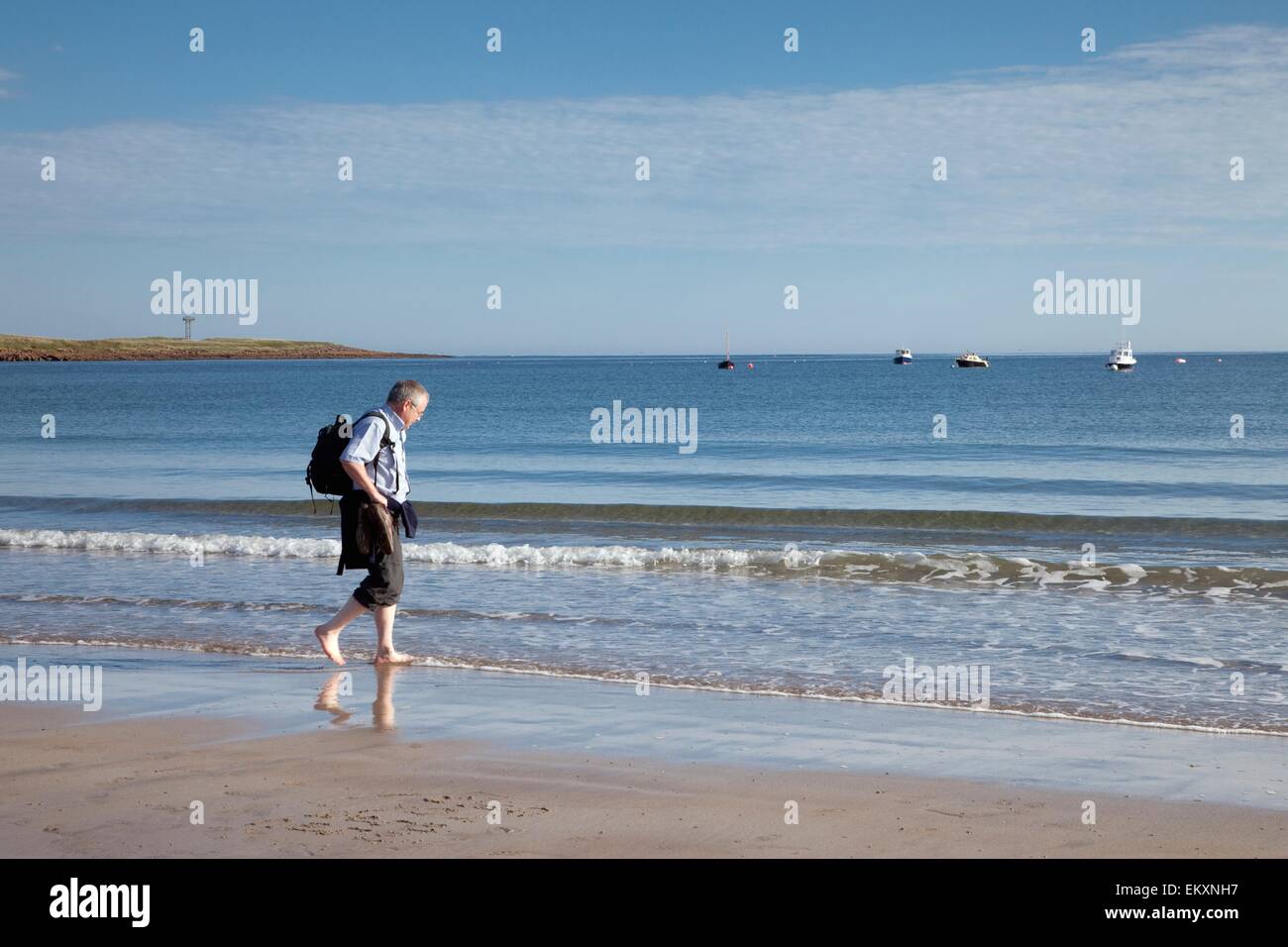 Man Walking Along Beach, Northumberland, England Stock Photo - Alamy