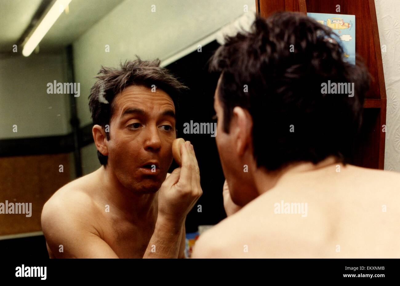 DJ Tiger Tim Stevens applies makeup to his face 18th February 1991 ...