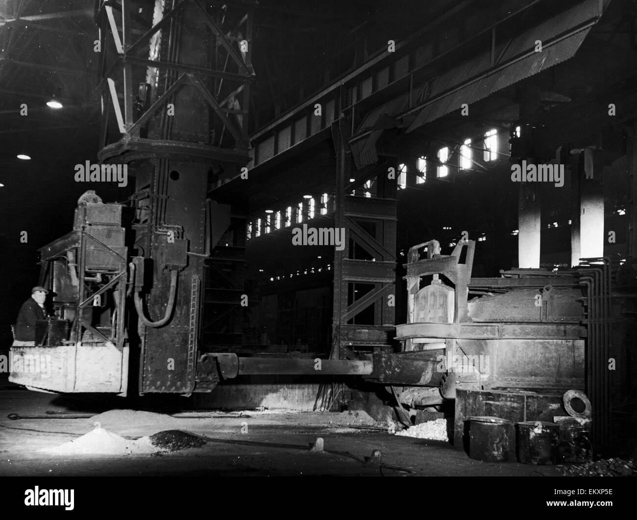 A mechanical charging machine feeding a 30 ton electric arc furnace at ...