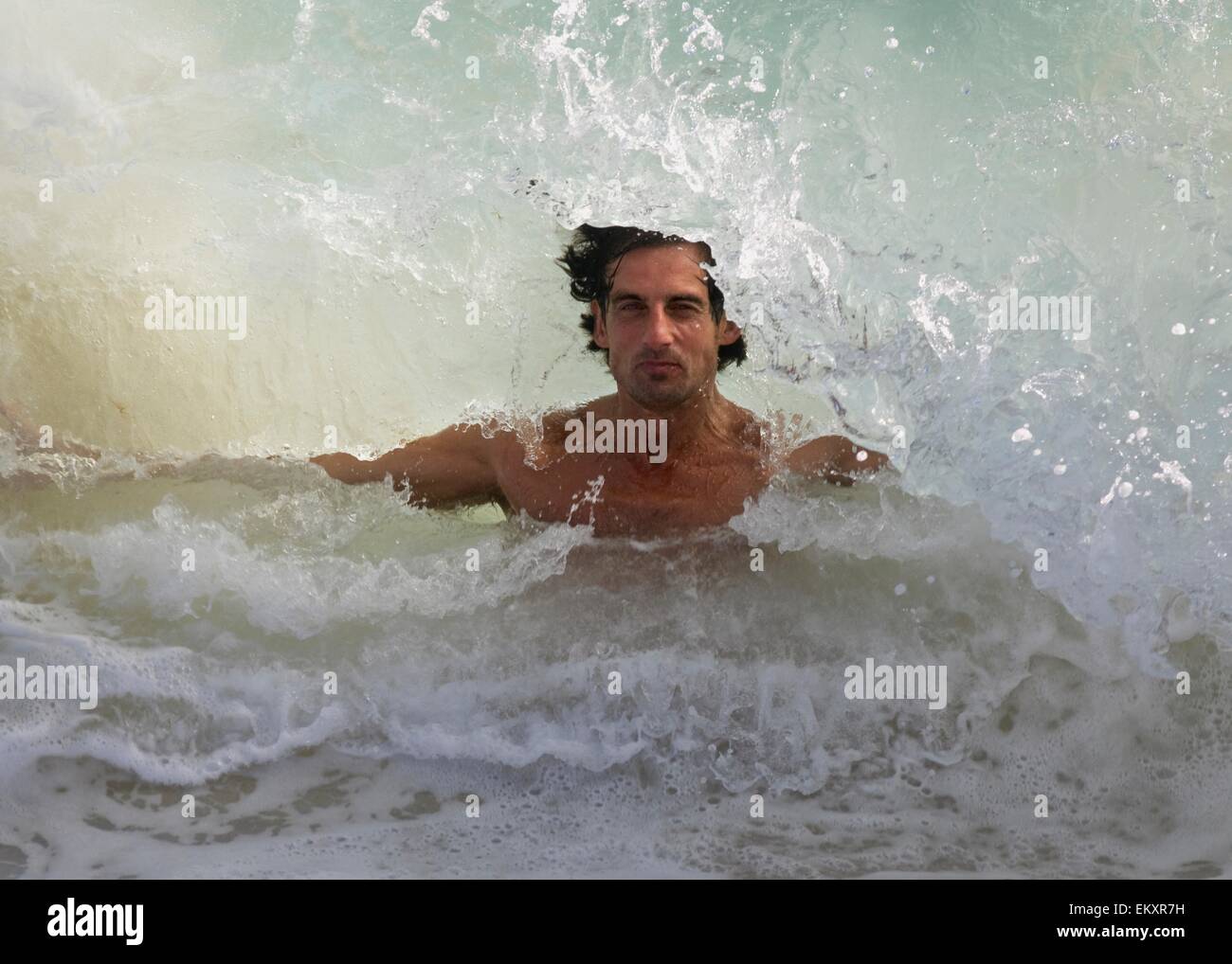 Wave Splashing Over Man Stock Photo - Alamy