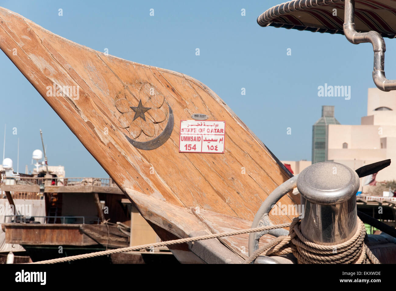 The bow of a traditional dhow boat moored in the dhow wharfage in Doha ...