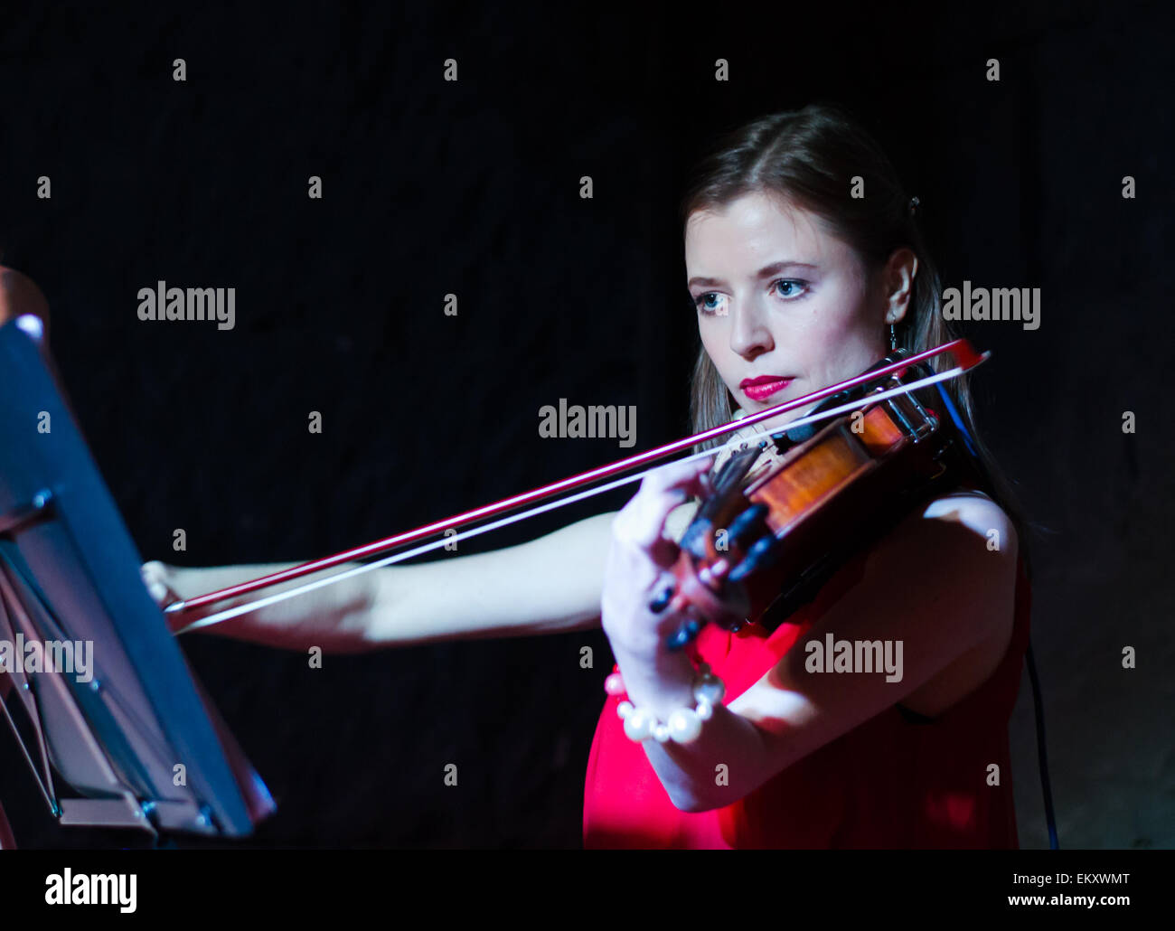 A concert of three woman (girls) at pink and red dresses at Minsk Loft ...