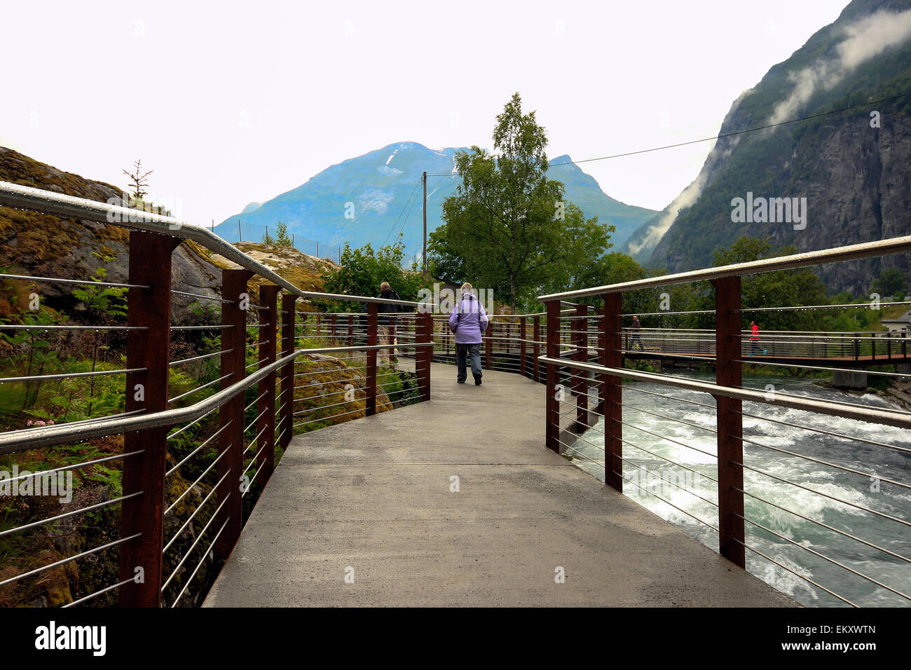 Tourists along a riverwalk, Geiranger, Norway, Scandinavia, Europe ...