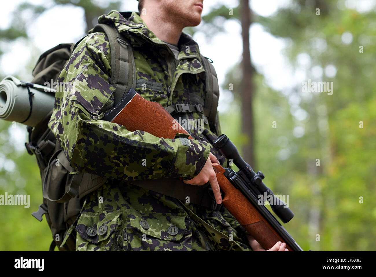 close up of soldier or hunter with gun in forest Stock Photo - Alamy