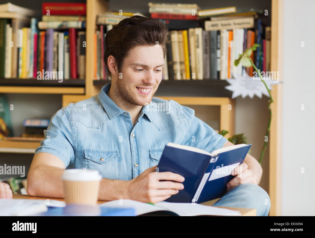 happy student reading book and drinking coffee Stock Photo - Alamy