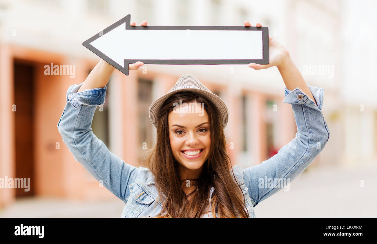 girl showing direction with arrow in the city Stock Photo - Alamy