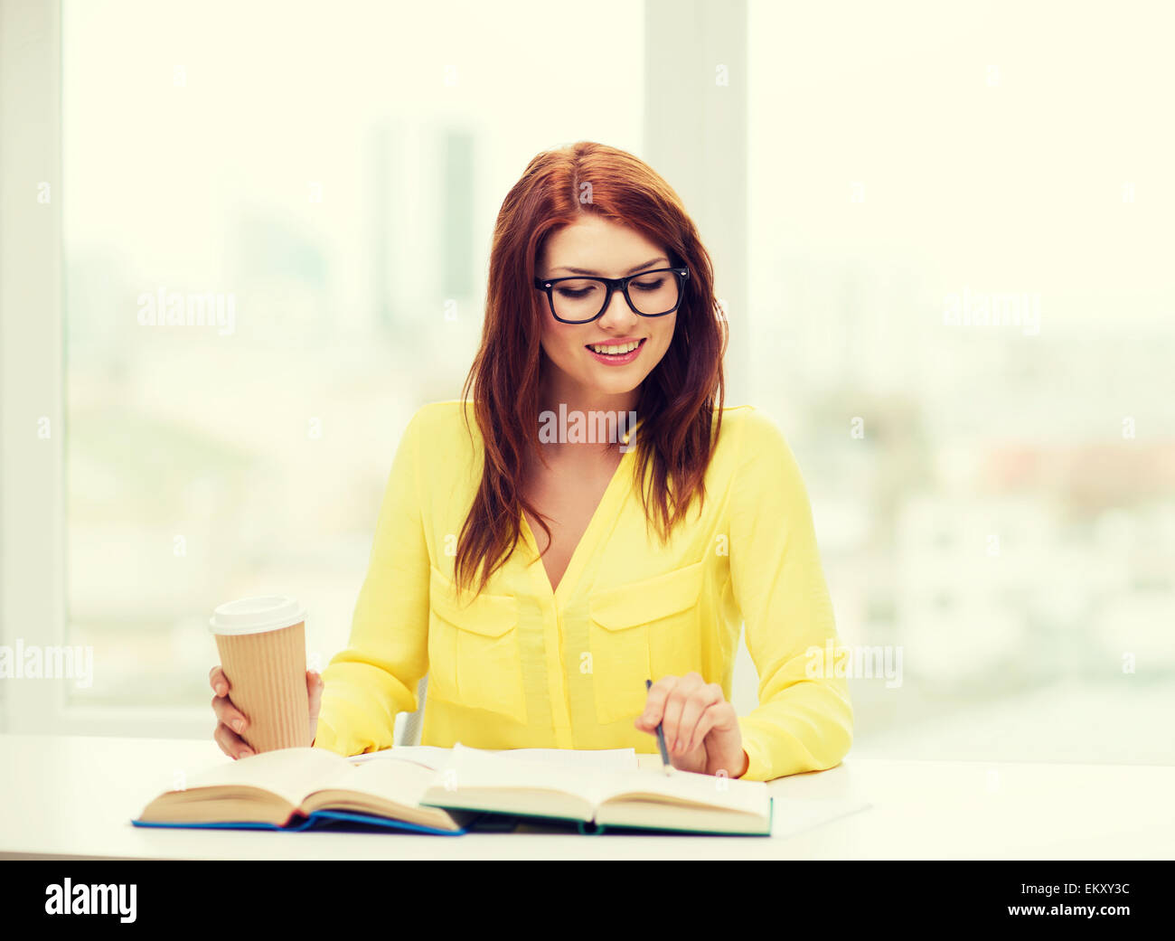 smiling student girl reading books in library Stock Photo - Alamy