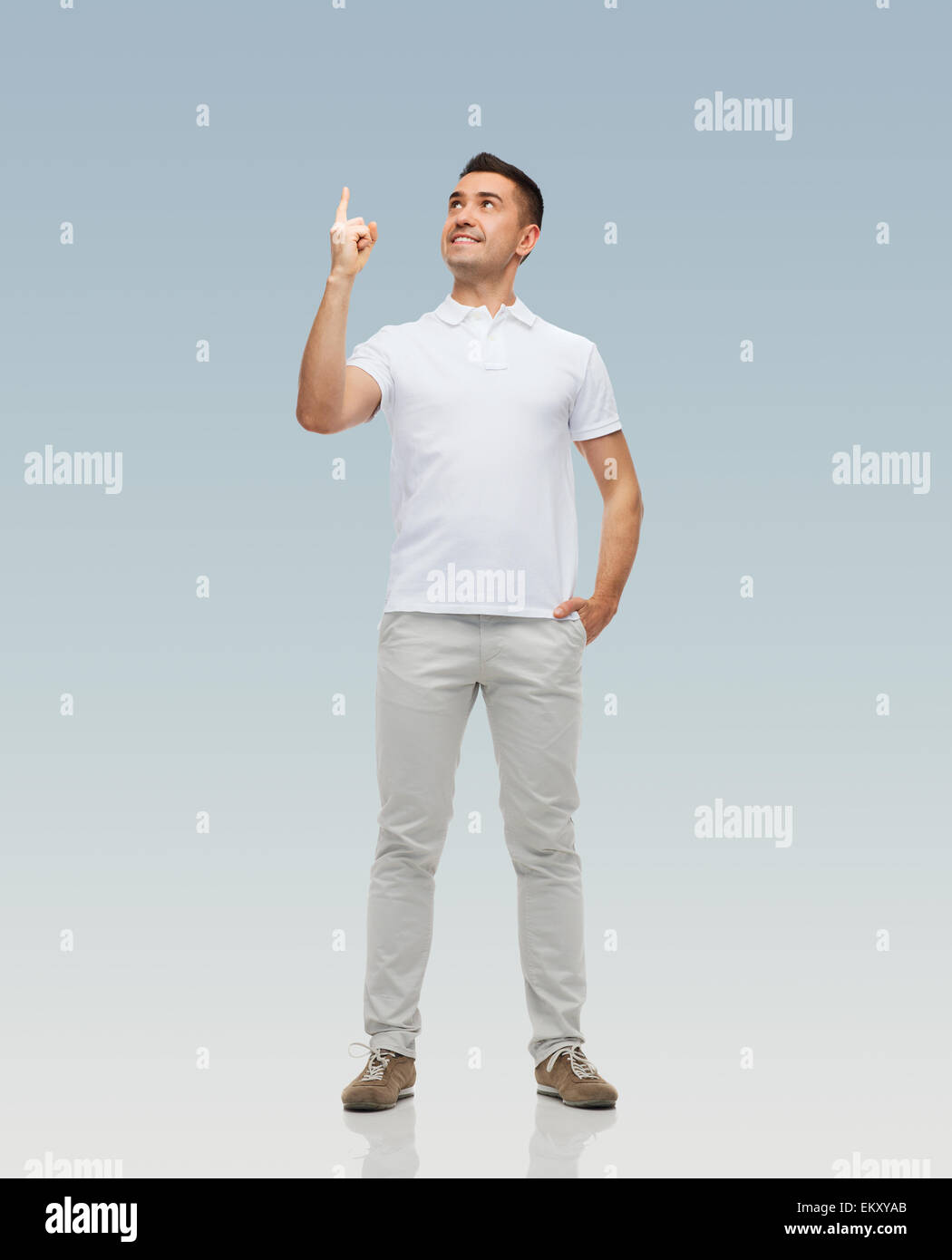 smiling man pointing finger up Stock Photo - Alamy