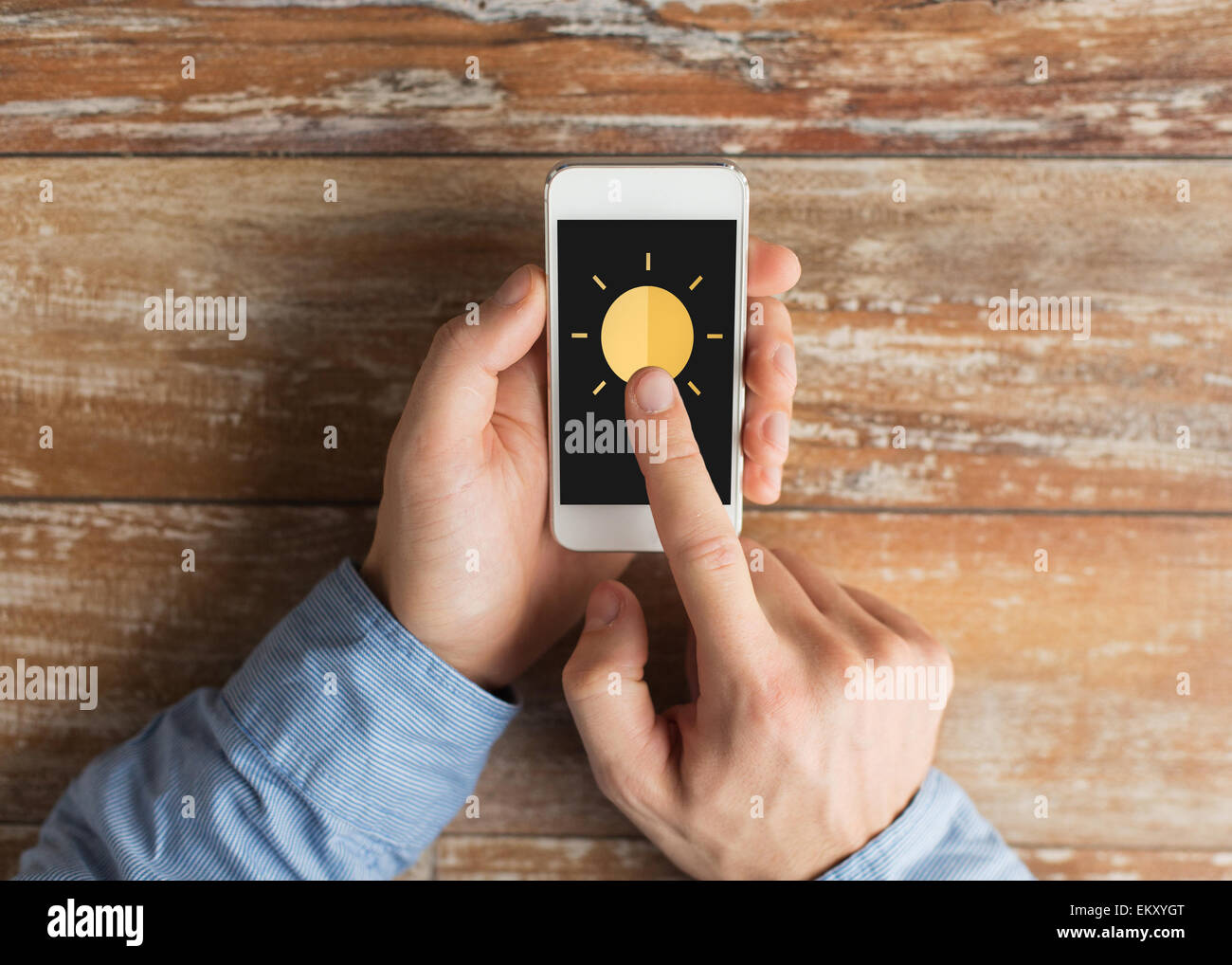 close up of hands with sun icon on smartphone Stock Photo - Alamy