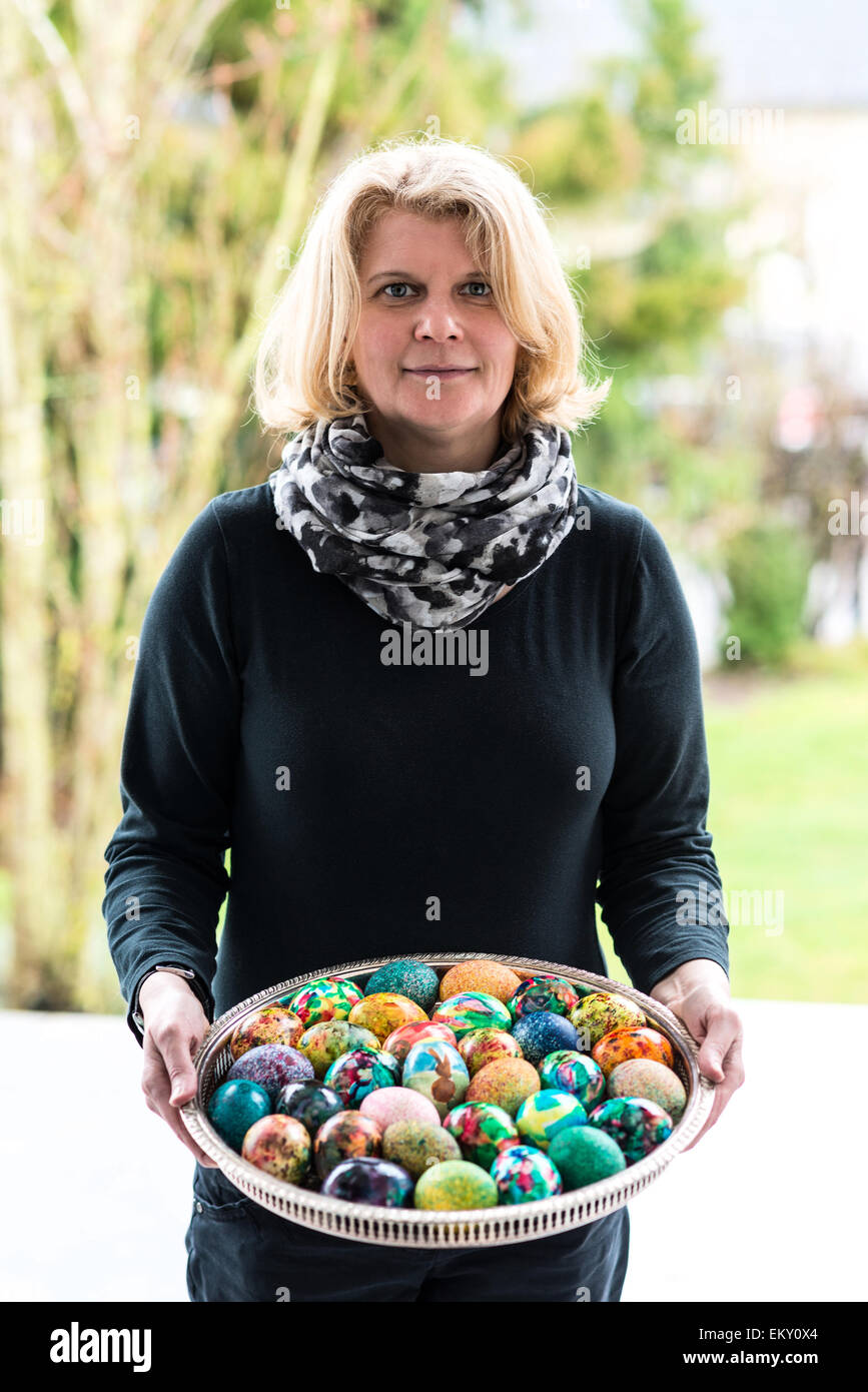 woman presenting easter eggs Stock Photo - Alamy