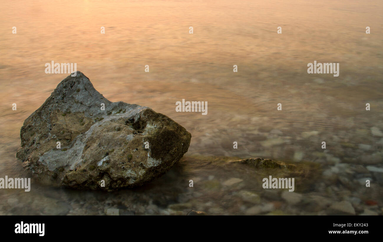 Rock in the water Stock Photo - Alamy