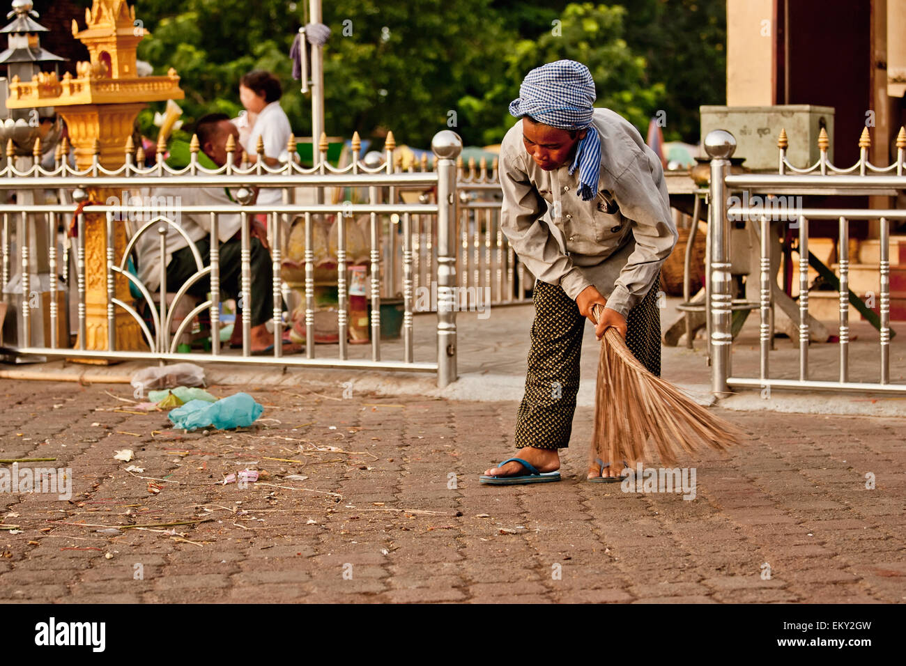 A Sweeper Cleans Up After The Night Before In Central Phnom Penh; Phnom ...