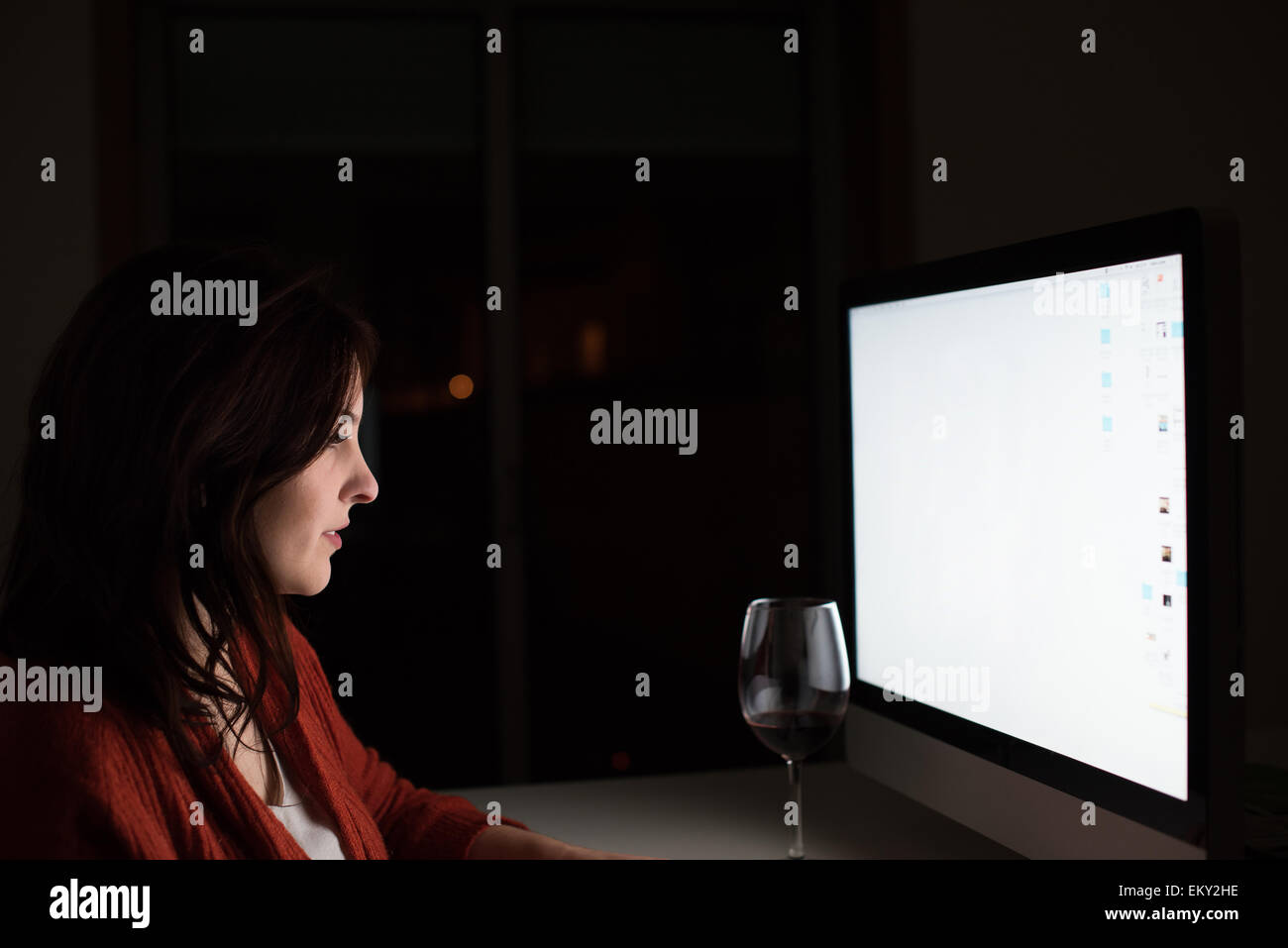 Woman watching online content on desktop Stock Photo - Alamy