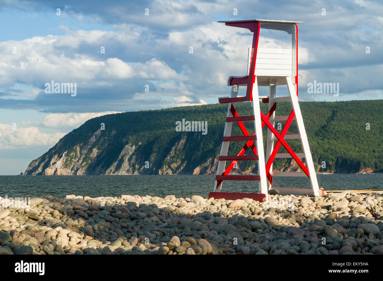 A lifeguard chair on rocky Ingonish Beach, with Cape Smokey in the ...
