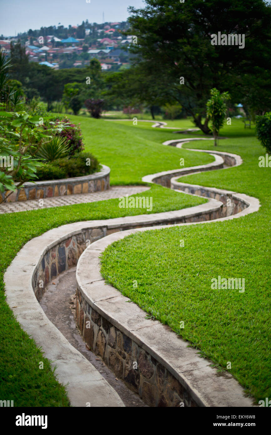 A stone walled path winding through gardens; Kigali, Rwanda Stock Photo ...