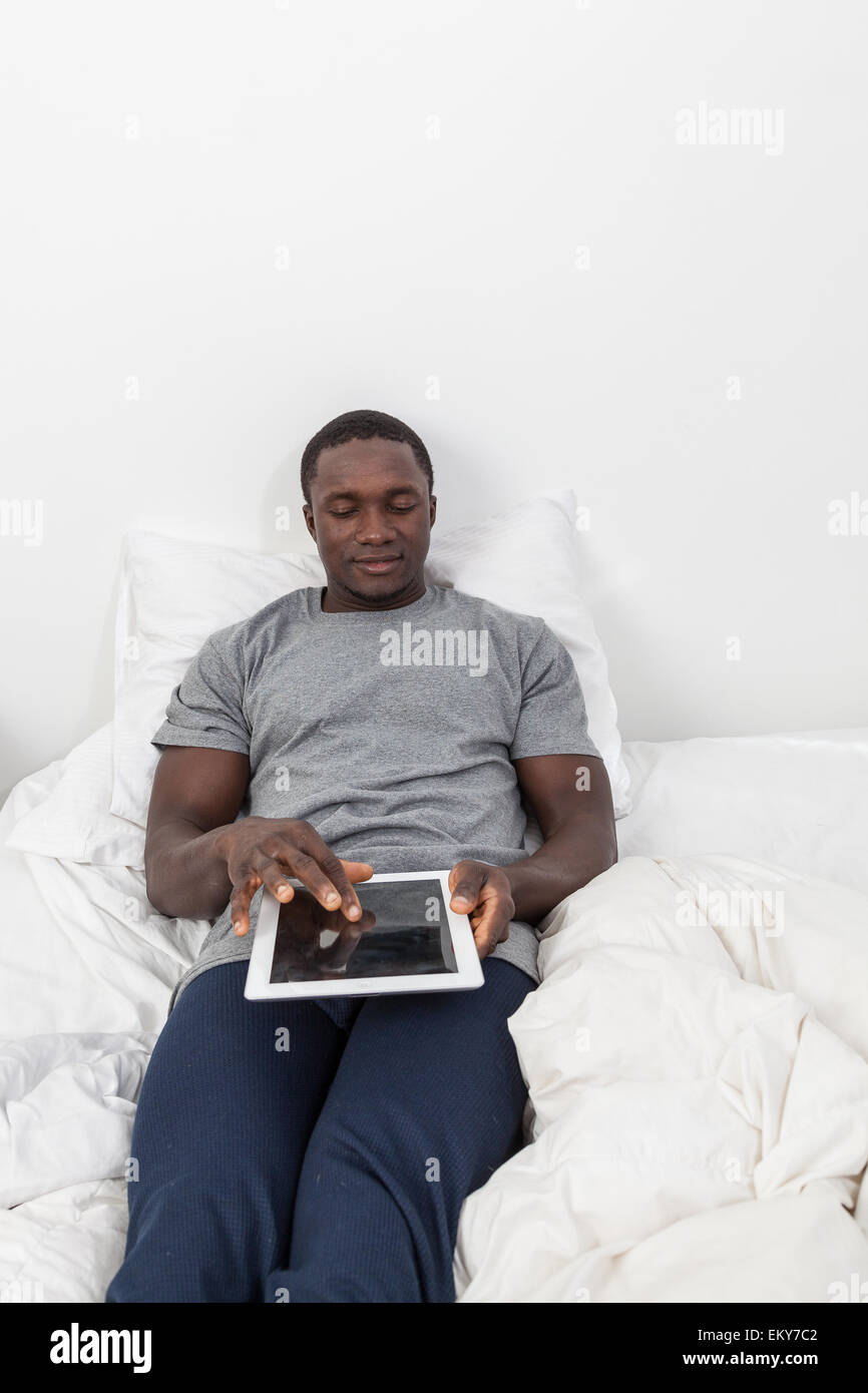 Black man on the bed Stock Photo - Alamy