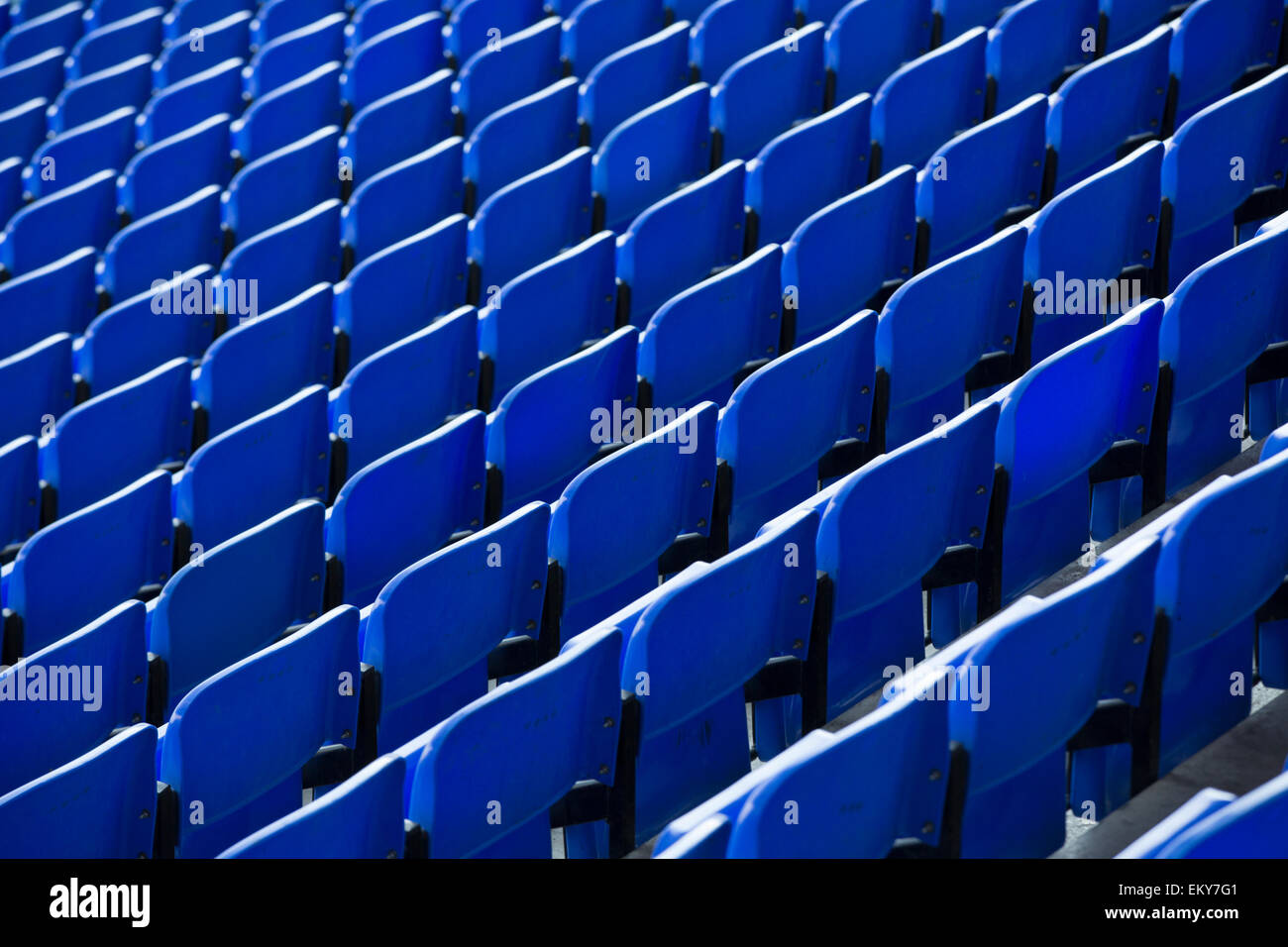 Blue seating in football stadium Stock Photo - Alamy