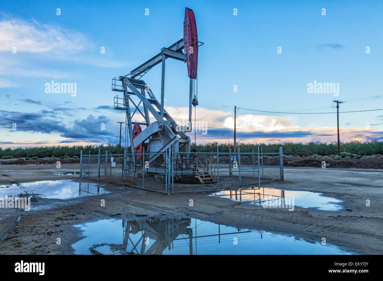 A pumpjack and surface water at oil well and fracking site in Shafter ...